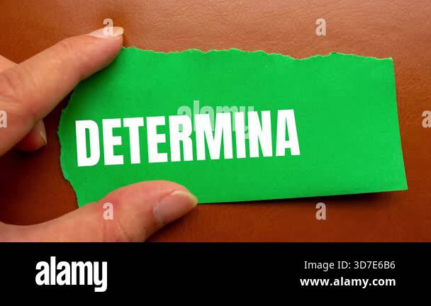 Determination message written on ripped torn paper background ...