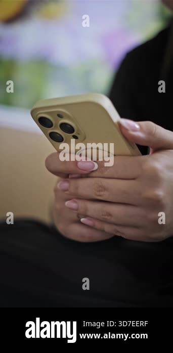 Vertical, close-up of a womans hands with a french manicure holding a ...