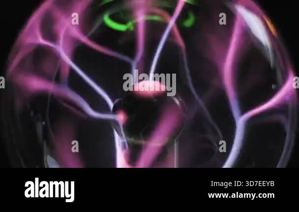 Closeup of a plasma globe with pink and purple electric arcs. White ...