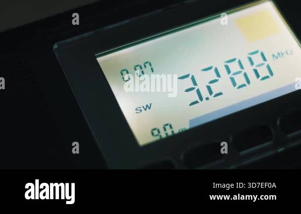Angled macro view of a modern radio receiver display powering on and ...