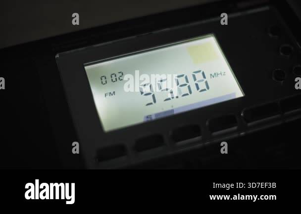 Close-up of a digital radio LCD screen scanning up through FM ...