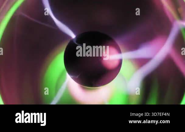 Macro view of a plasma ball central electrode emitting pink and purple ...