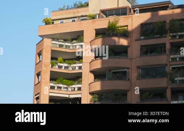 Modern residential building with greenery covered terraces and ...