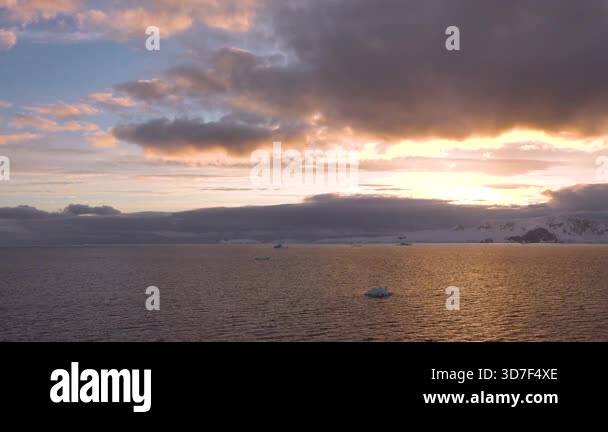 A beautiful sunset paints the sky with shades of orange and purple as ...