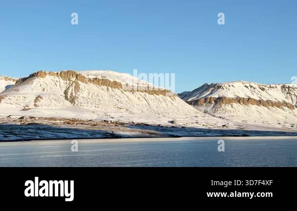 Stunning cliffs tower over calm waters in this serene arctic location ...