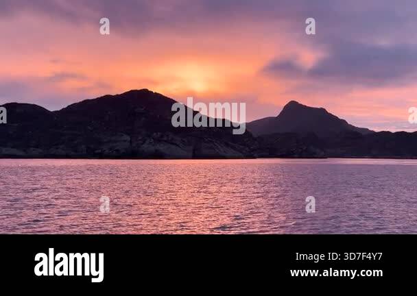 A beautiful sunset paints the sky with shades of orange and purple as ...