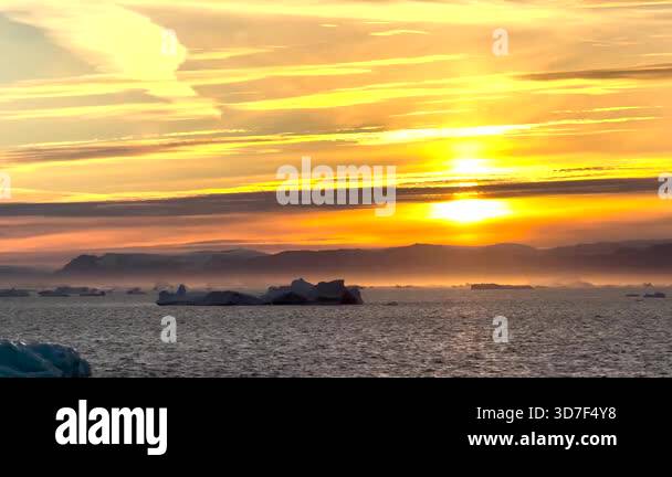 A beautiful sunset paints the sky with shades of orange and purple as ...