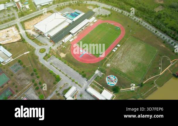Aerial view of a modern sports complex featuring a running track ...