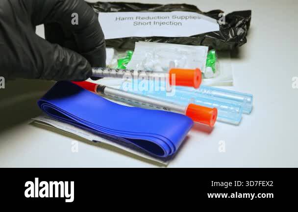 Open Harm Reduction kit supplies displays on the table. Short Injection ...