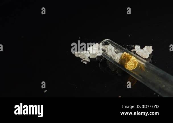 Crystal meth drug in rocks with smoking crack pipe on the table of ...