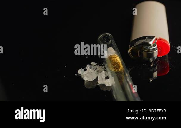 Crystal meth drug in rocks with smoking crack pipe on the table of ...