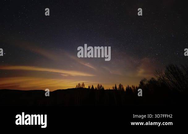 Time-lapse of a tranquil night sky illuminated by the rising moonlight ...