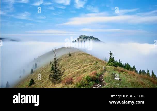 timelapse showing fast-moving fog rolling over a mountain ridge during ...