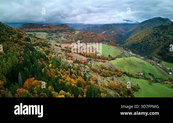 Aerial hyperlapse view of autumn mountain hills covered with vibrant ...