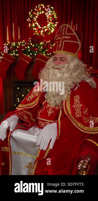 Smiling Saint Nicholas sitting in ornate red and gold costume by ...