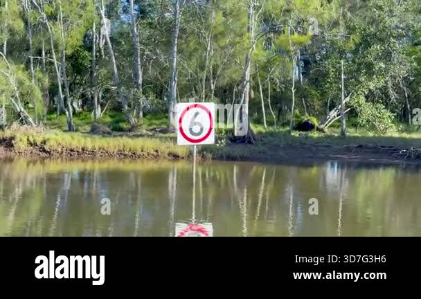 Calm river scene with speed limit sign Stock Video Footage - Alamy