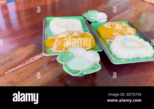 Mango sticky rice served on a wooden table in natural light at a Phuket ...