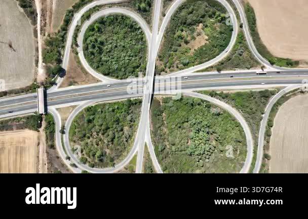Aerial top down view of a symmetrical cloverleaf highway interchange ...