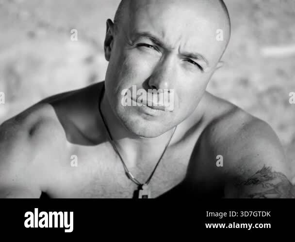 A serene man smiling softly with closed eyes in darkness Stock Video ...
