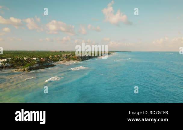 Long tropical coastline with ocean waves and beach town Tulum in Mexico ...