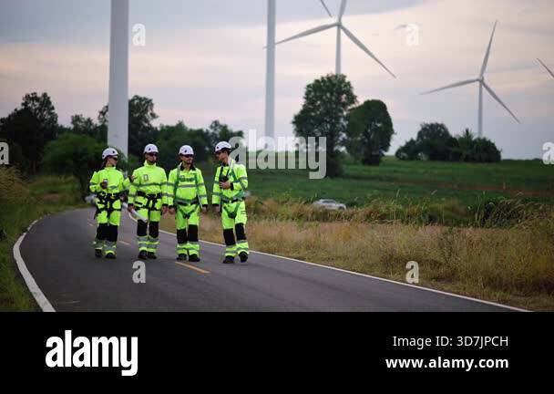 Engineers wearing safety helmets and reflective jackets inspecting a ...