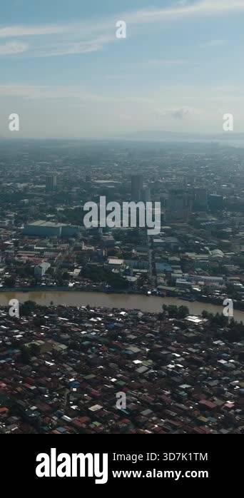 Drone view of residential area in Davao City. Houses in riverside ...