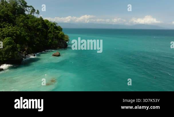 Coastal beach with rocks and ocean waves. Turquoise water under blue ...