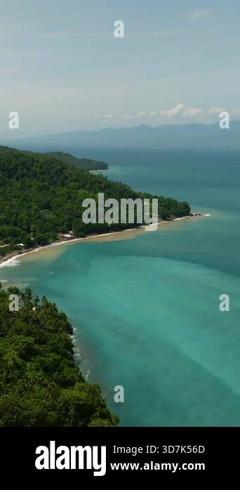 Waves on coastline under blue sky and clouds. Samal Island. Davao ...