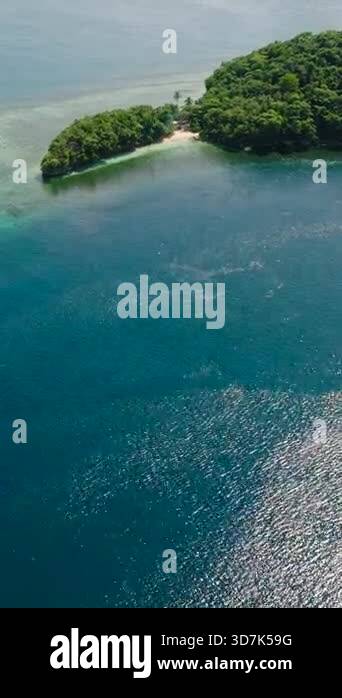 Vertical view of tropical island with sandy beach and blue sea. Millari ...