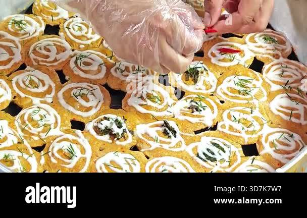 A Thai street vendor making Thai Steamed Fish Custard (Hor Mok), one of ...