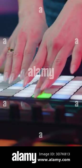 Unrecognizable professional female DJ performing drum parts pressing ...