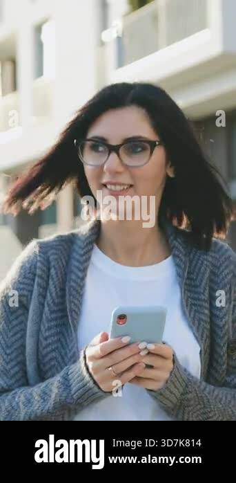 Young beautiful caucasian freelance woman using smartphone while ...