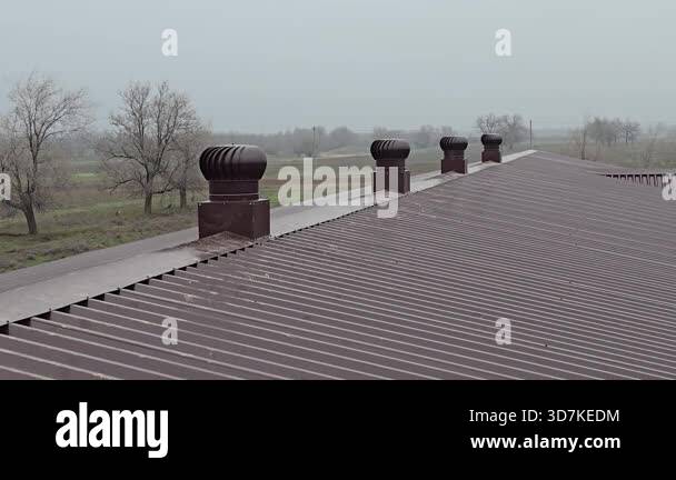 Turbo ventilator deflectors on the metal roof of an industrial building ...