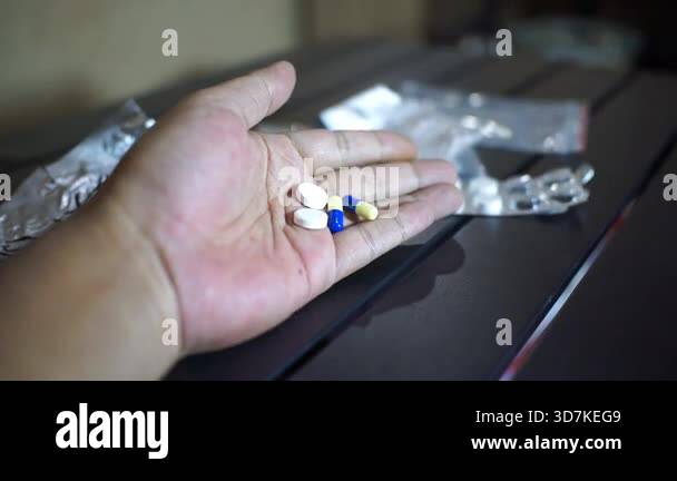 Medications in capsule and tablet form shown in a persons palm Stock ...