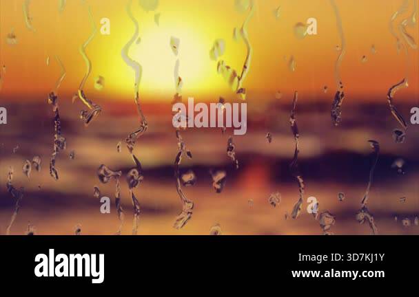Rain days, rain falling on window surface on sunset or sunrise ...