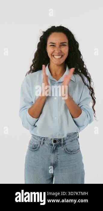 Cheerful young woman applauding and clapping hands. Happy female model ...