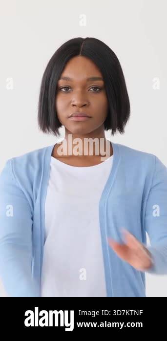Portrait of a serious young African American woman making a stop ...
