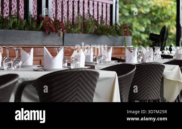 A serene restaurant scene in Phuket, Thailand, showcasing elegantly set ...