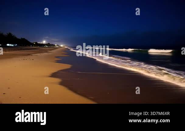 Ocean Waves Crash On Sandy Beach Under Starry Night Sky With Distant ...