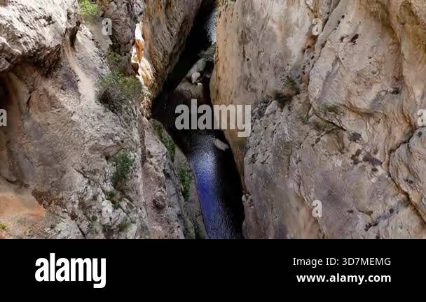 Drone captures stunning footage flying through a narrow rocky canyon ...