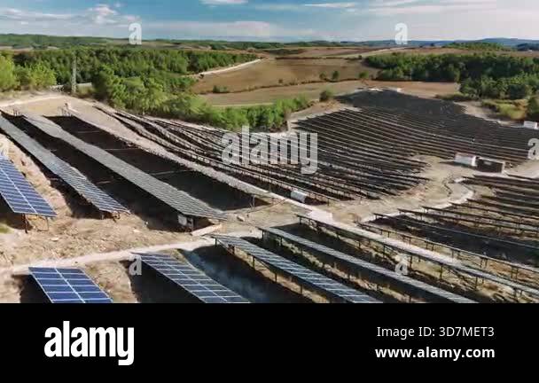 Sprawling solar farm featuring rows of photovoltaic panels on a serene ...