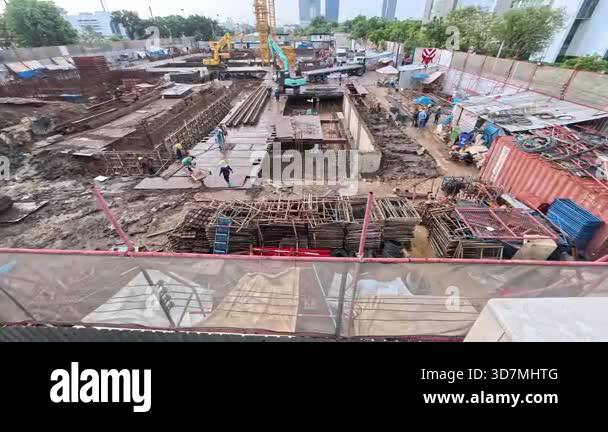 High angle view shows Workers constructing concrete forms for equipment ...