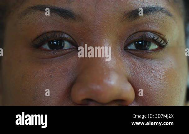 Macro close up of African American womans eyes, calm and introspective ...