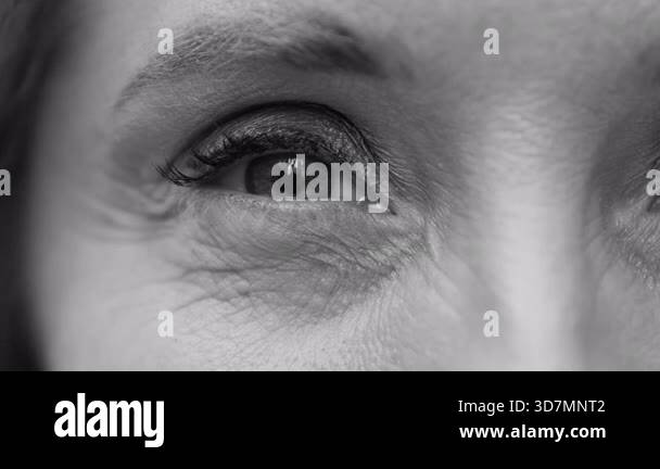 Close-up portrait of middle-aged womans eye showing soft and reflective ...