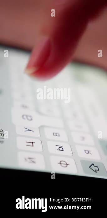 fast thumb action on device, closeup of fingers rapidly typing cyrillic ...