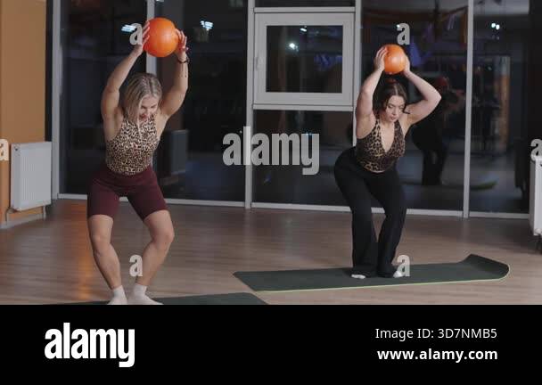 Intense fitness workout with dynamic squats and stretching in a gym ...