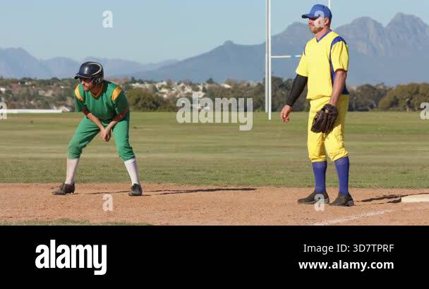 On pitch male first baseman catching throw to tag baserunner out at ...