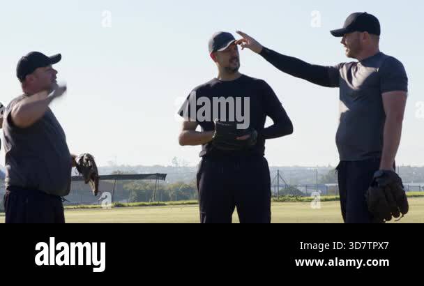 Senior men pointing glove upward and debating angle for drill, tossing ...