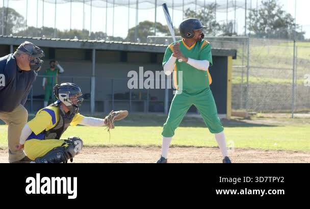 Pitch arriving prompting male catcher securing ball in mitt after ...