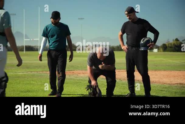Removing batting helmet, five male baseball teammates supporting ...